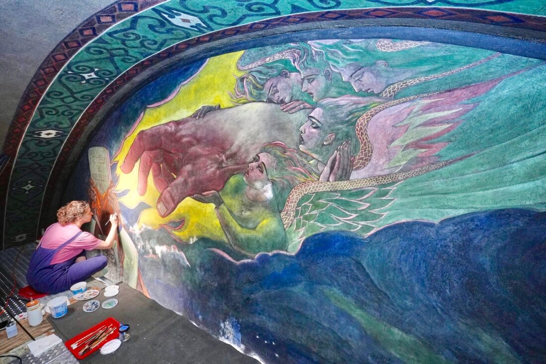 Cleaning inside a historic church painted with murals that reflect ...